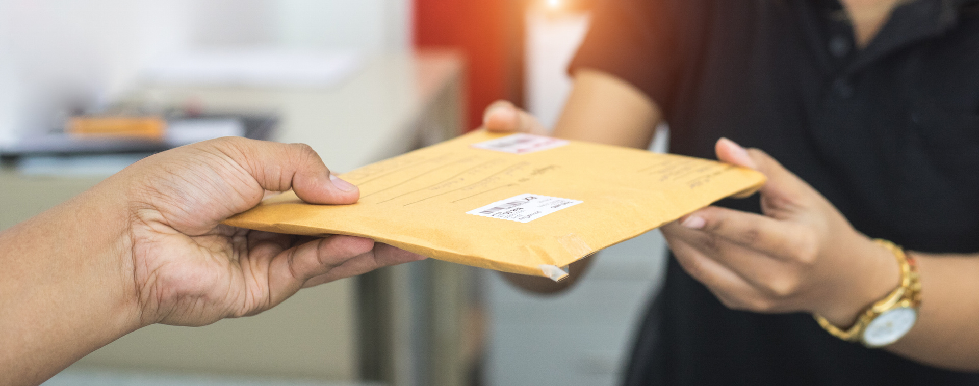 male hand send mail envelope to the female of post office before ...